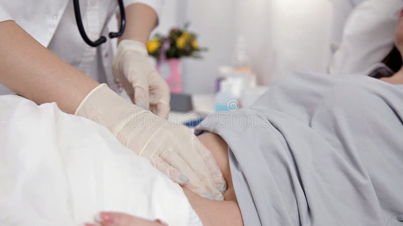 Palpation of the Abdomen in the Medical Center. the Doctor Examines the ...