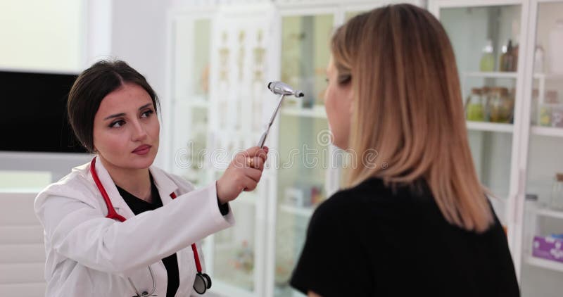 Doctor Examines Pupils of Patient Using Flashlights in Clinic Stock ...