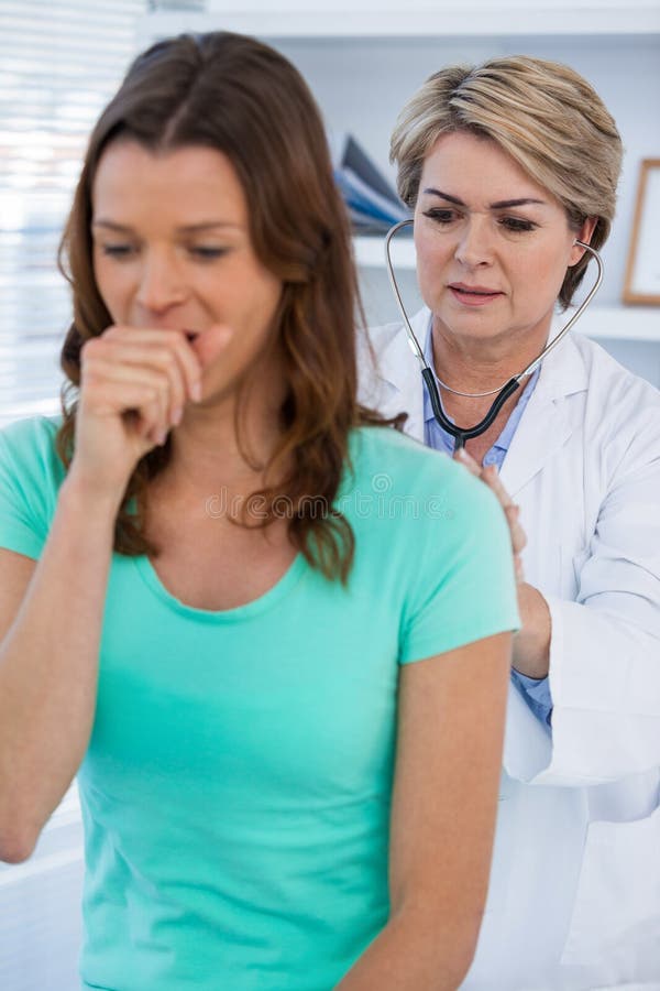 Doctor Examining Coughing Patient with Stethoscope Stock Image - Image ...