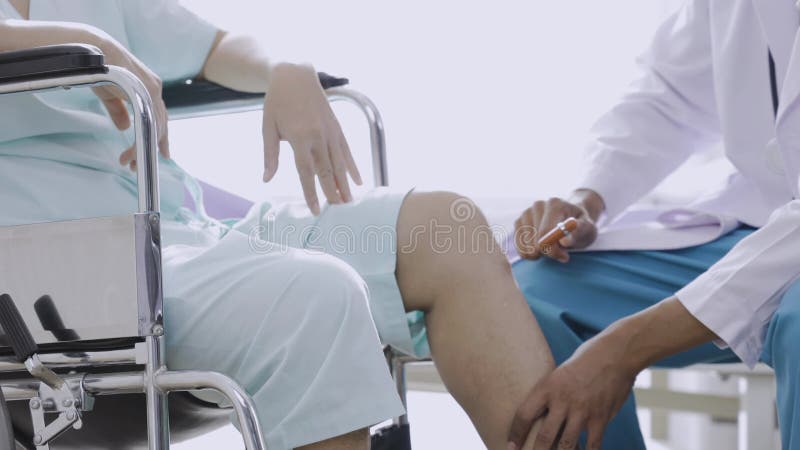 The Doctor is Examining the Knee of an Elderly Patient. the Neurologist ...