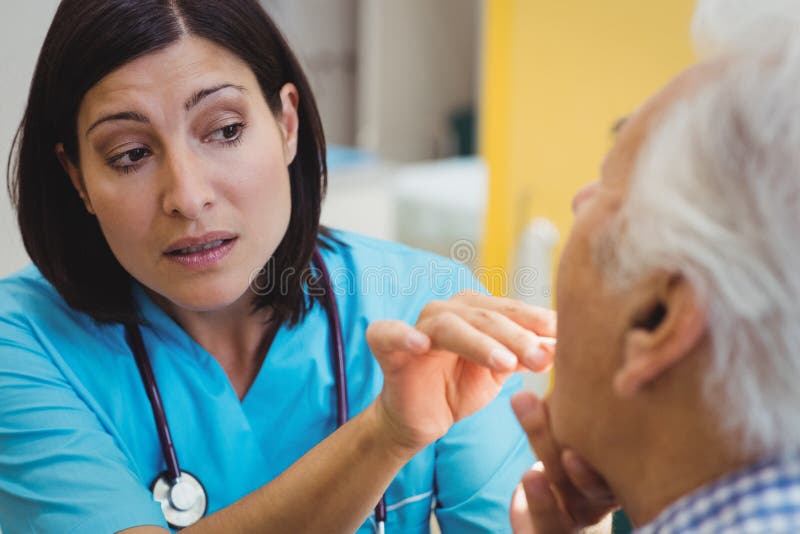 Doctor examining a patient stock image. Image of patient - 77222691