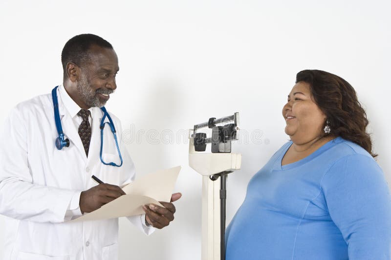 Doctor Checking Boy S Weight Stock Photo - Image of hispanic, boomer ...