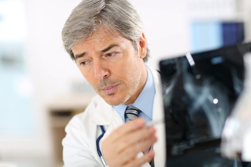 Doctor Examining X-ray Results Stock Photo - Image of examination ...