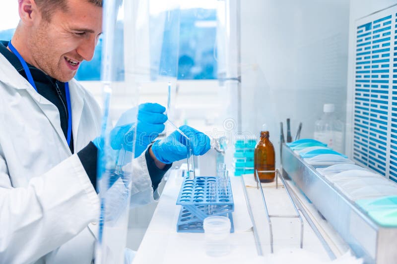 Doctor Examining Samples Using Pipettes in a Modern Laboratory Stock ...