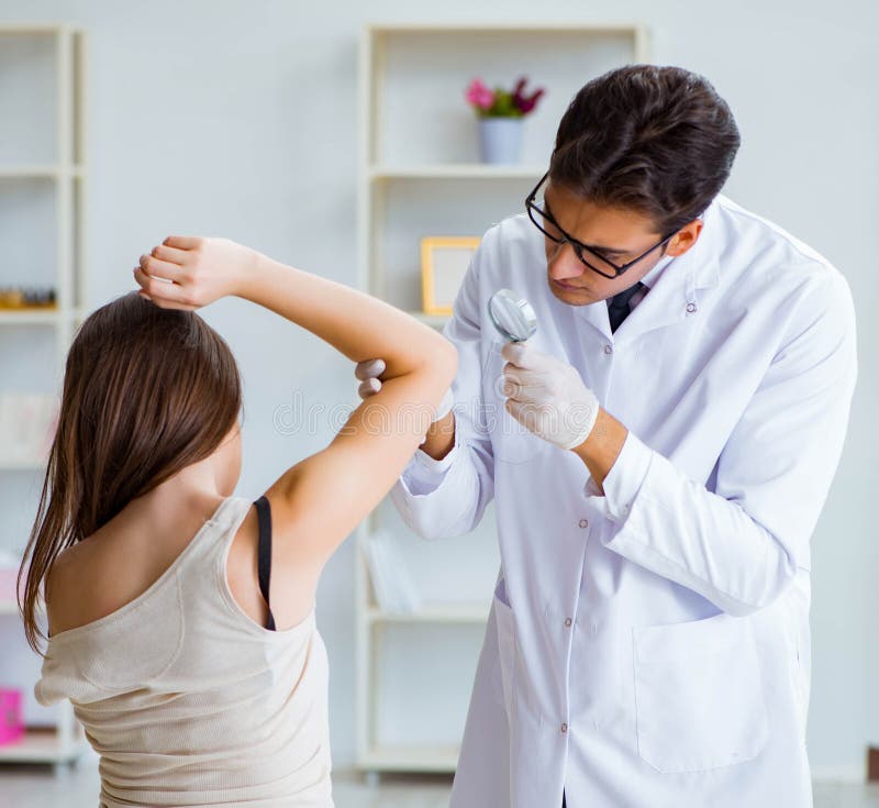 Doctor Examining the Skin of Female Patient Stock Photo - Image of ...