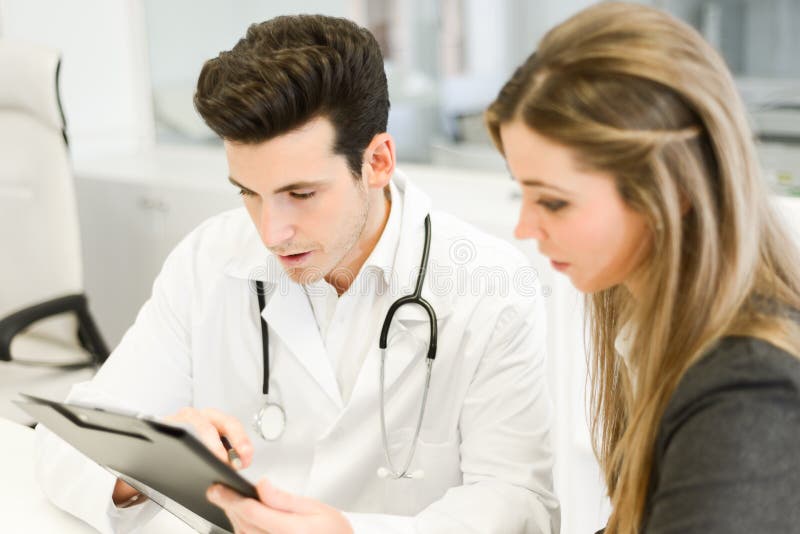 Doctor Explaining Diagnosis To Her Female Patient Stock Photo - Image ...
