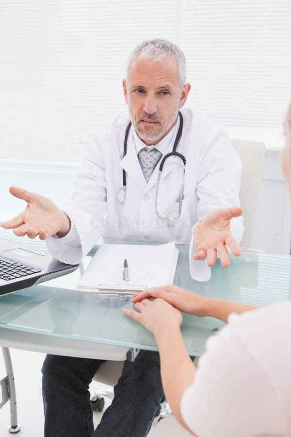 Doctor Explaining at His Patient Stock Photo - Image of coat, front ...