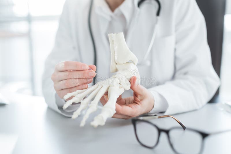 Doctor Explaining Operation To Foot on Bone Model Stock Photo - Image ...