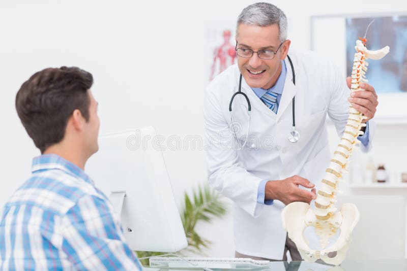 Doctor Explaining a Spine Model To Patient Stock Image - Image of ...