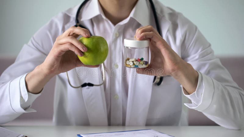 Doctor Explaining Vitamins Benefits, Comparing with Fresh Apple ...