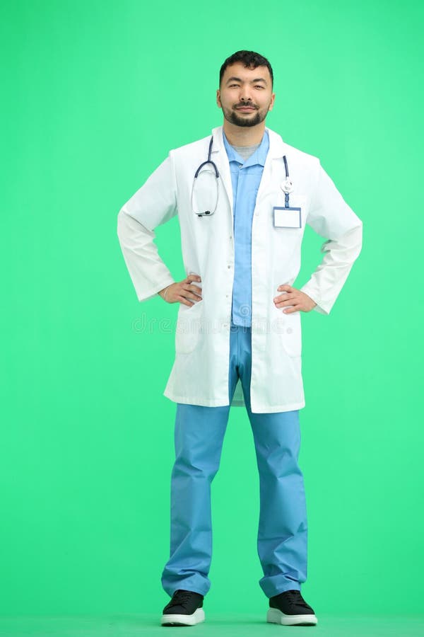 Doctor, Full-length, on a Green Background, Hands on Hips Stock Photo ...