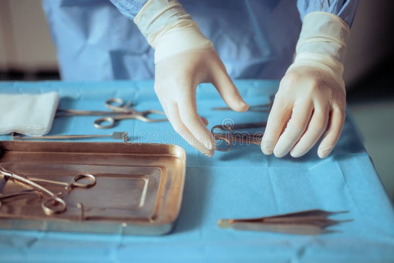 Surgeon Preparing His Instruments for the Surgical Operation Stock ...