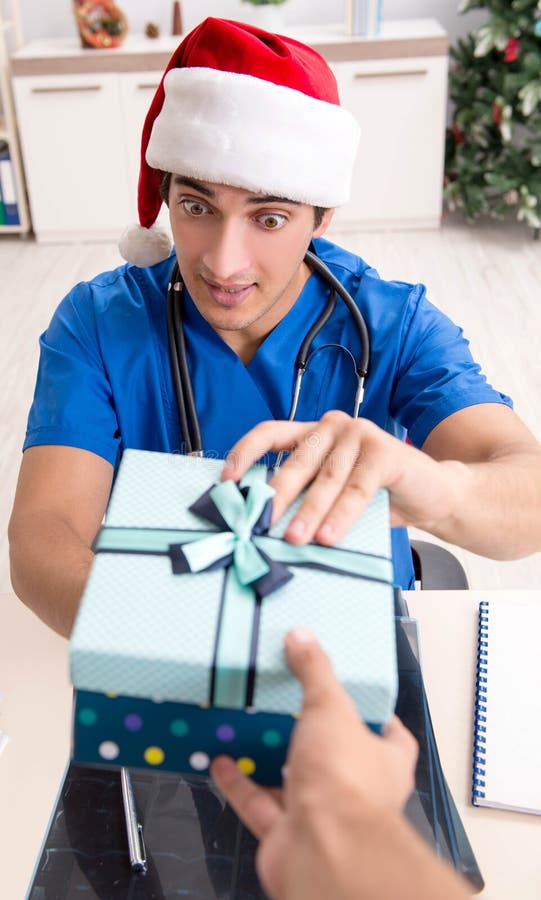 Doctor with Gift Box in the Hospital Stock Photo - Image of merry ...