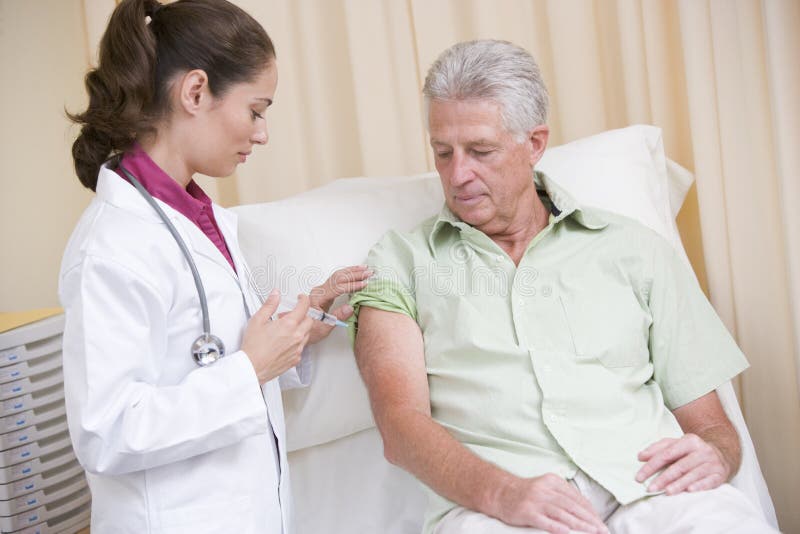 Doctor Giving Man Needle in Exam Room Stock Photo - Image of fifties ...