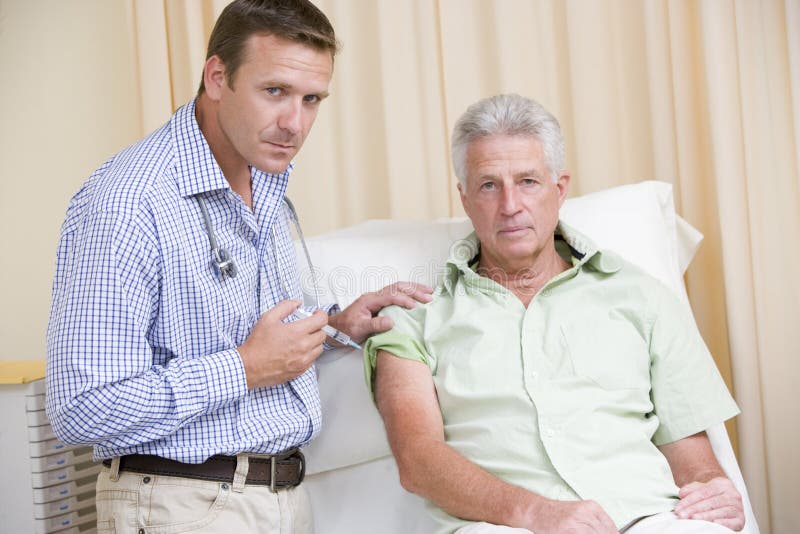 Doctor Giving Man Needle in Exam Room Stock Photo - Image of injection ...