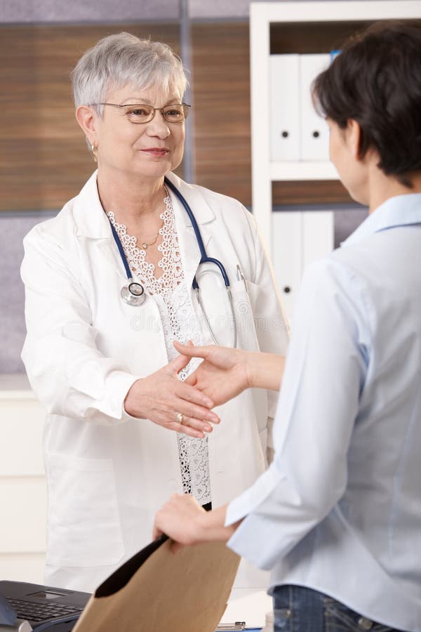 Doctor greeting patient stock photo. Image of american - 18076582