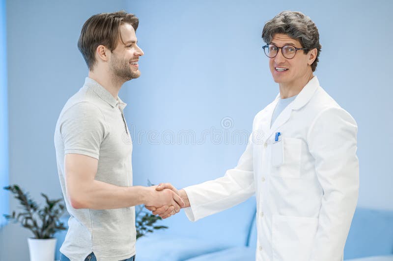 Doctor Greeting a Patient and they Looking Contented Stock Photo ...