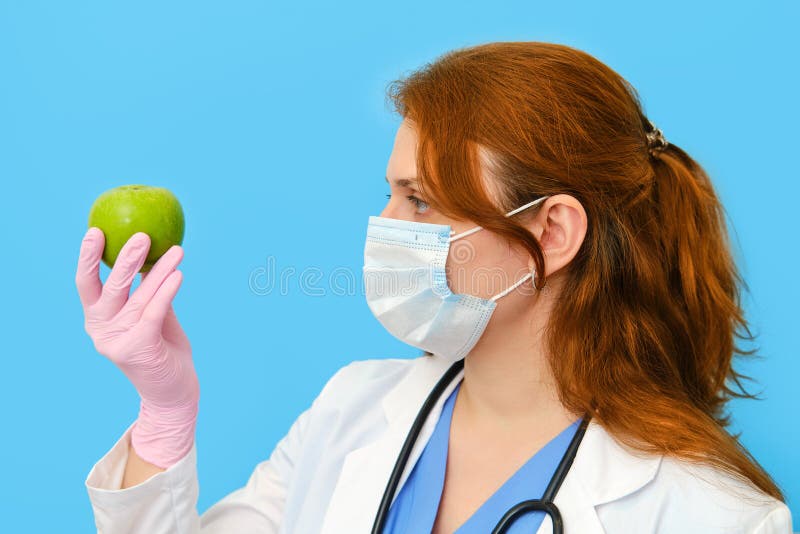 Doctor Hand with an Apple on a Blue Background Stock Image - Image of ...