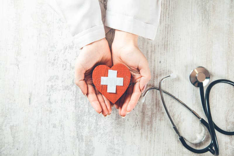 Doctor hand heart on desk stock image. Image of uniform - 208179177
