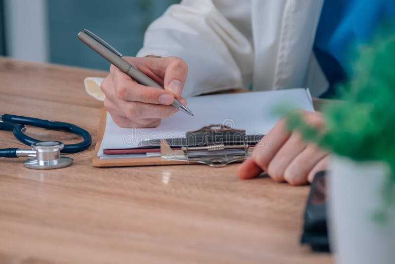 Doctor Hand Writing on Document Stock Image - Image of treatment ...