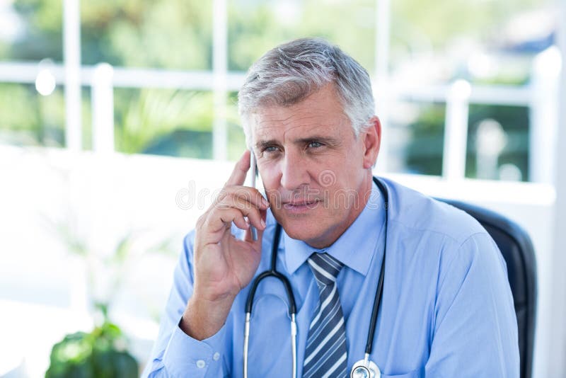 Doctor having phone call stock image. Image of adult - 54763687