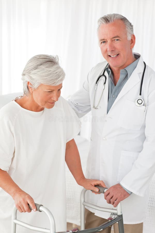 Doctor Helping His Patient To Walk Stock Photo - Image of lifestyle ...