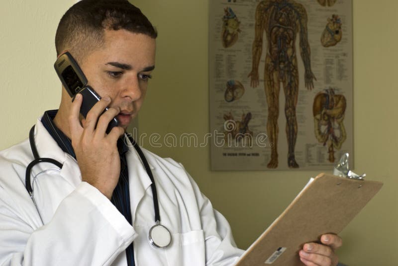 Doctor on his Cell Phone stock image. Image of technology - 10018875