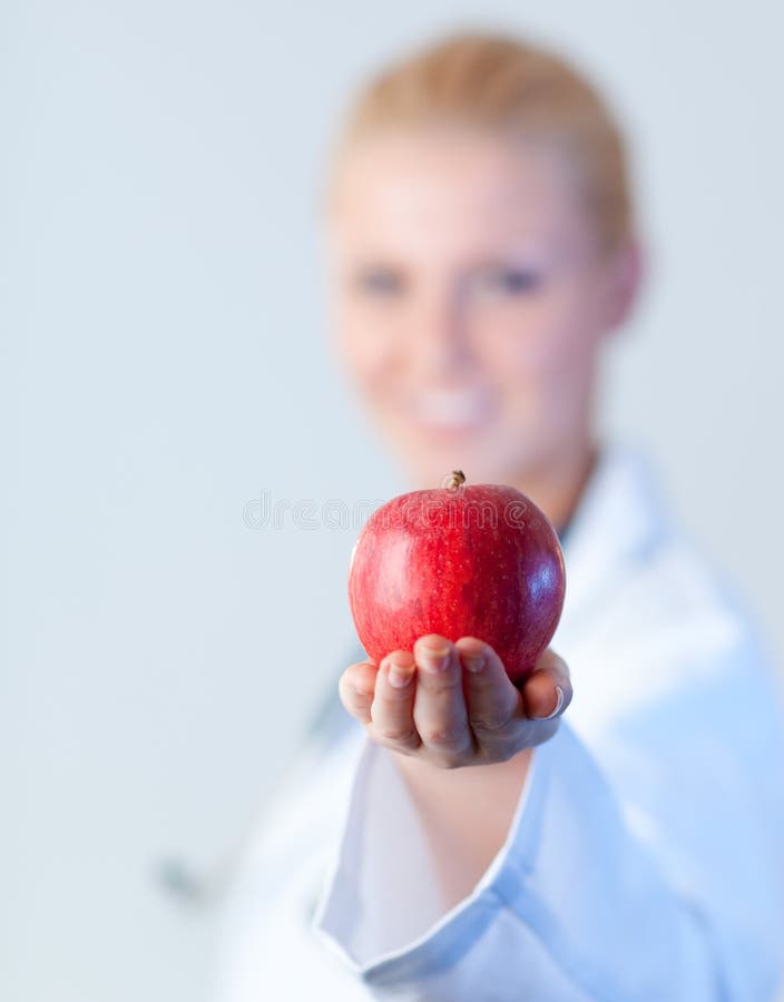 Doctor Holding an Apple with Focus on the Apple Stock Image - Image of ...