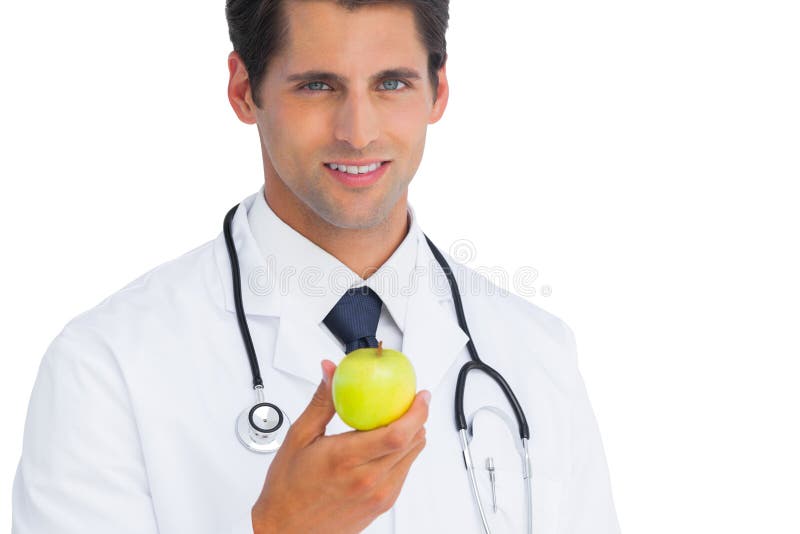 Doctor Holding an Apple and Smiling Stock Photo - Image of profession ...