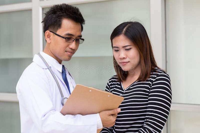 Doctor Holding Application Form while Consulting Patient Stock Image ...