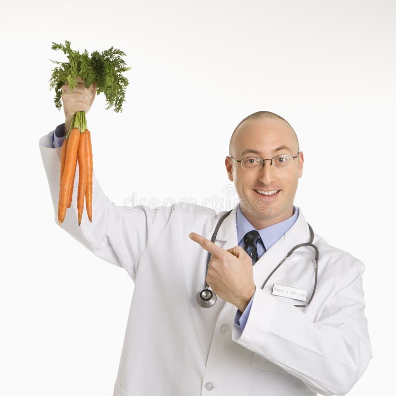 Doctor holding carrots. stock image. Image of health, doctor - 2425997