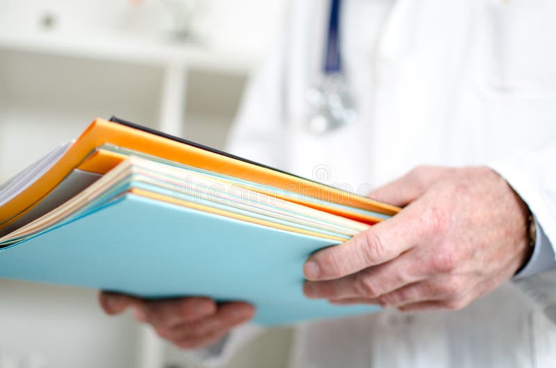 Doctor holding files stock photo. Image of folders, office - 47213106