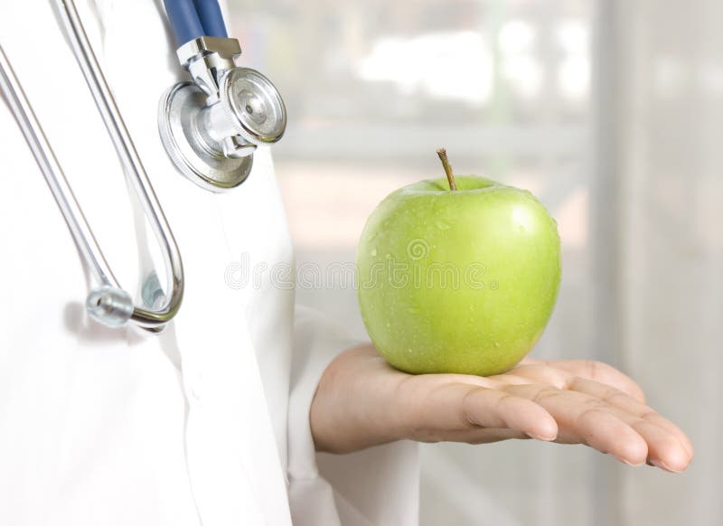 Doctor Holding a Green Apple Stock Photo - Image of hand, apple: 26092142