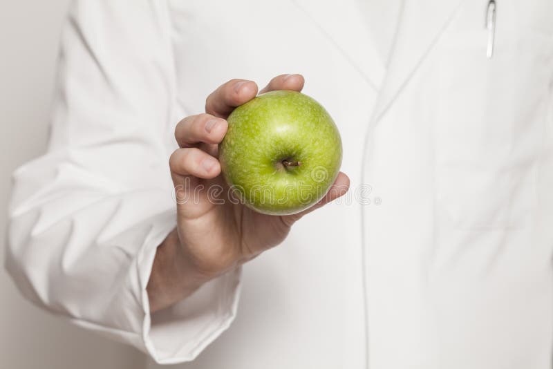 Doctor Holding a Green Apple Stock Photo - Image of hand, doctor: 53086074