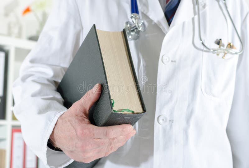 Doctor Holding a Medical Book Stock Image - Image of research, medical ...