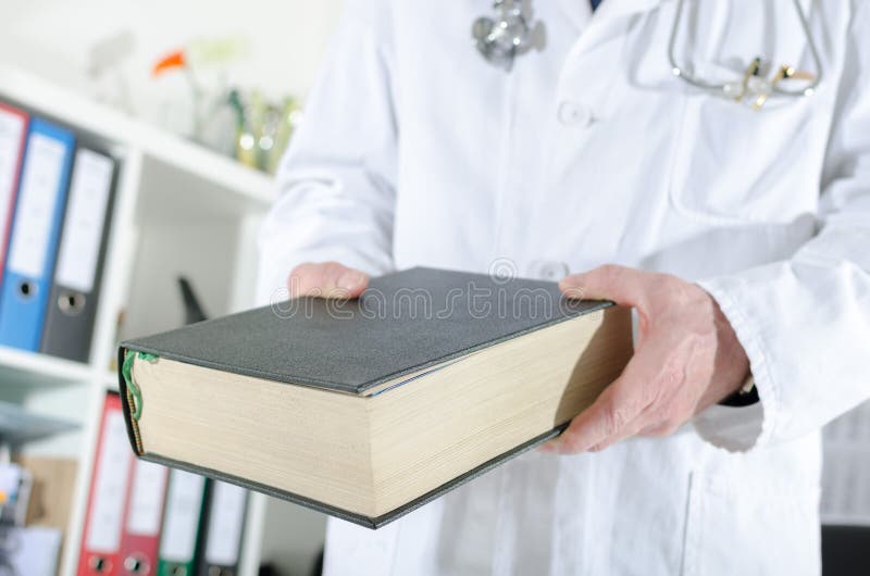 Doctor Holding A Medical Book Stock Photo - Image of care, hospital ...