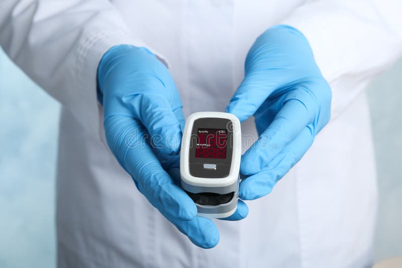 Doctor Holding Modern Fingertip Pulse Oximeter Stock Image - Image of ...