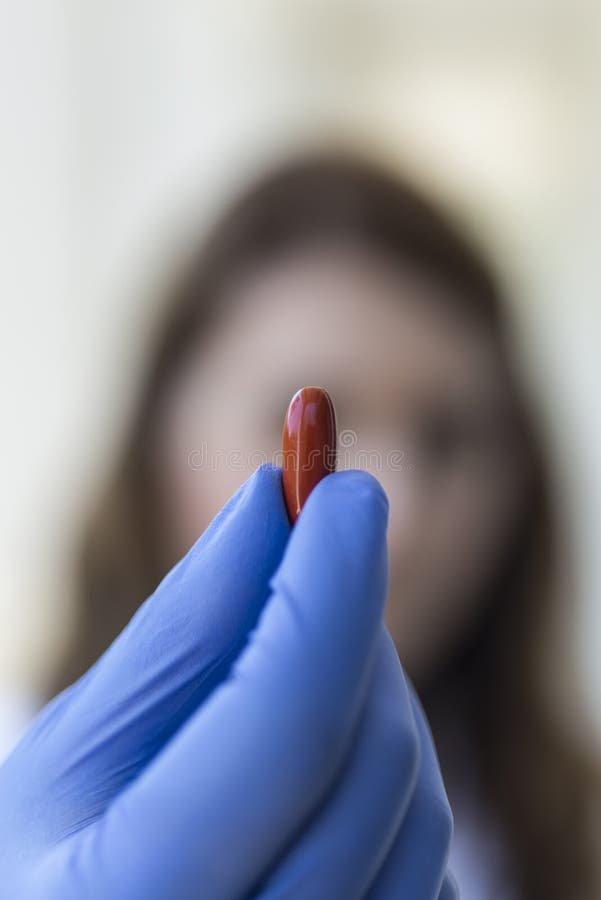 Doctor holding red pill stock photo. Image of antioxidant - 58337888