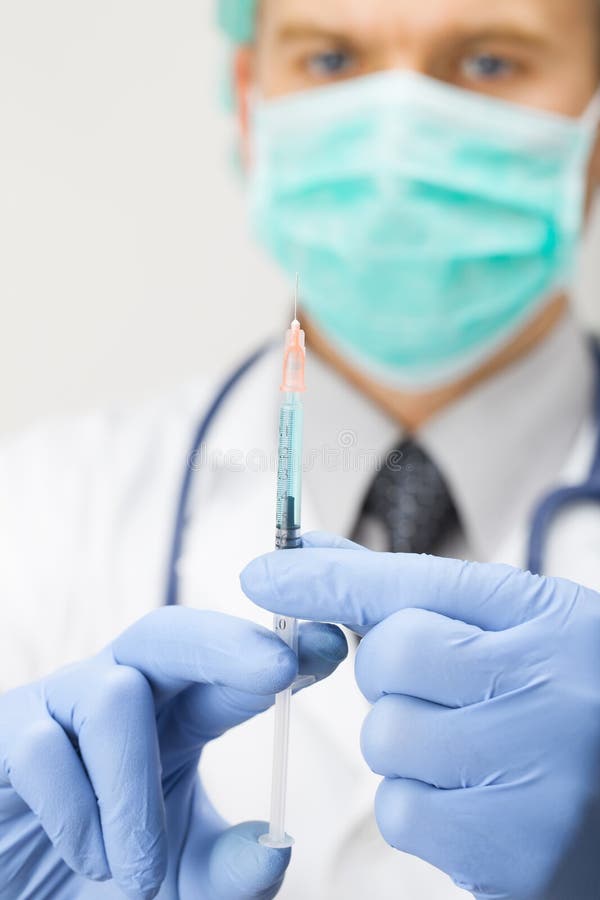 Doctor Holding Syringe with Two Hands and Getting Ready To Make ...