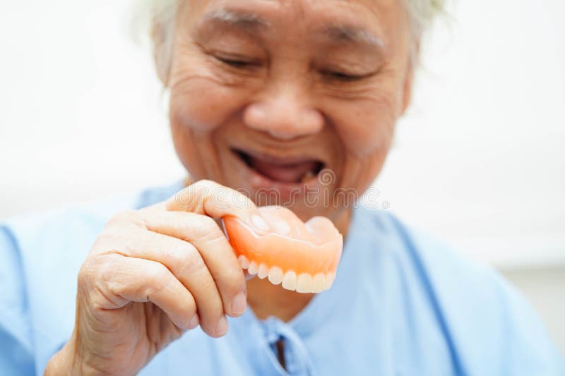 Doctor Holding Teeth Denture in Hand for Dentist Studying about ...