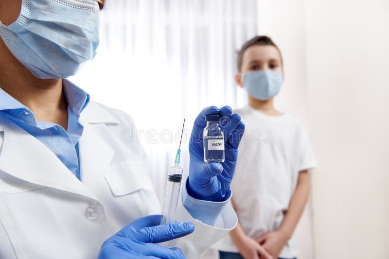 Doctor Pediatrist Holding a Vaccine Vial and Syringe and Preparing an ... Doctor Pediatrist Holding a Vaccine Vial and Syringe and Preparing an ...