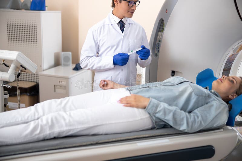 Doctor Holding Venflon Catheter and Looking at Patient Stock Image ... Doctor Holding Venflon Catheter and Looking at Patient Stock Image ...