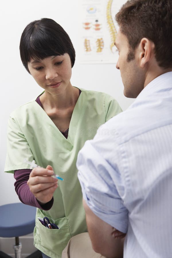Doctor Injecting Patient stock photo. Image of health - 29664092