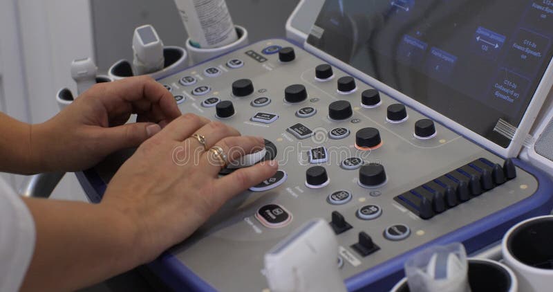 The Doctor Keeps His Hands on the Keyboard of the Ultrasound Machine ...