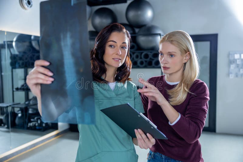 Doctor in Lab Coat Explaining Xray Results To a Female Patient Stock ...