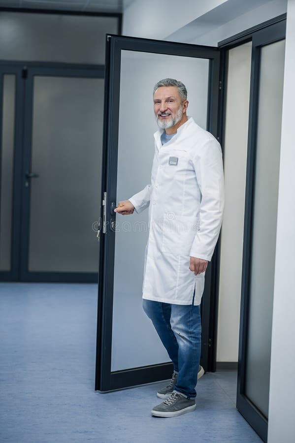 A Doctor in a Lab Coat Opening the Door of His Office Stock Image ...