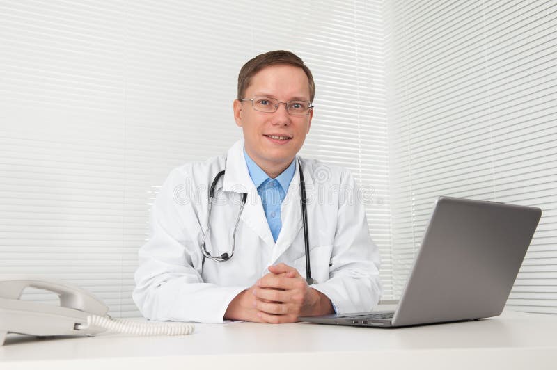 Doctor with laptop stock image. Image of happy, coat - 26410367