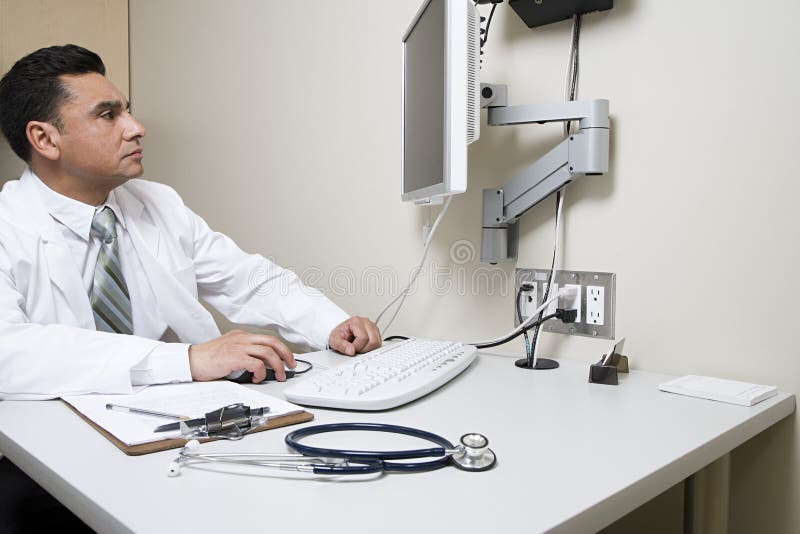 Doctor Looking at Computer Screen Stock Photo - Image of knowledge ...