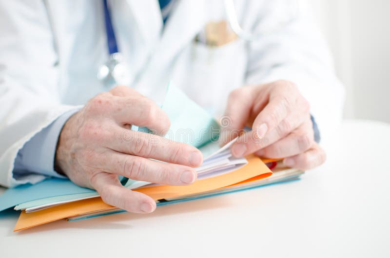 Doctor looking for a file stock photo. Image of medicine - 47213476