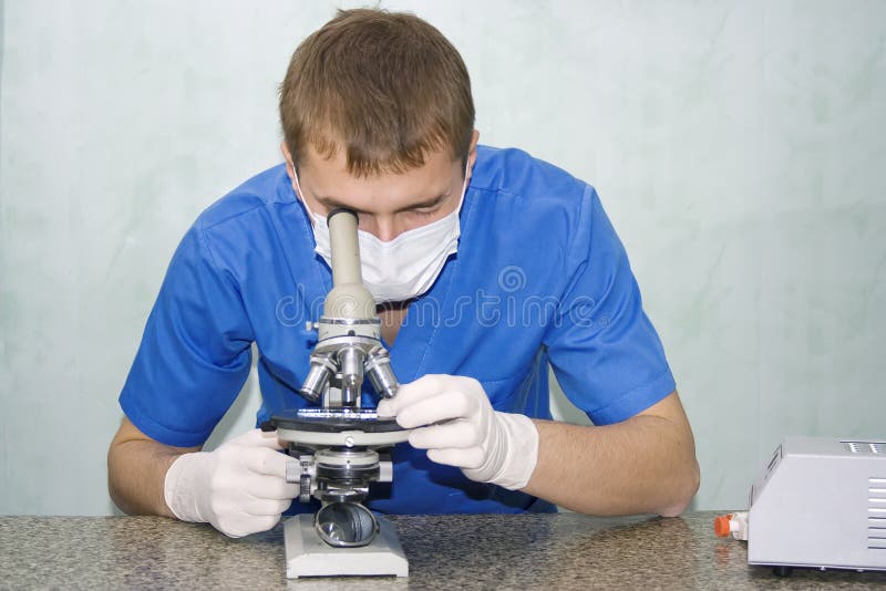 Doctor Looking into a Microscope Stock Photo - Image of chemist, people ...